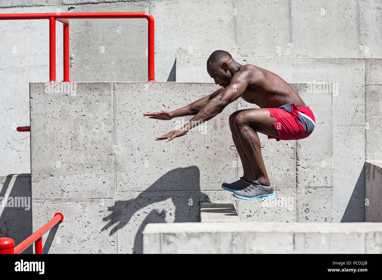 Athlete doing exercises at stadium Stock Photo - Alamy