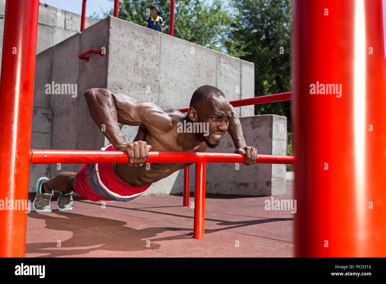 Athlete doing exercises at stadium Stock Photo - Alamy