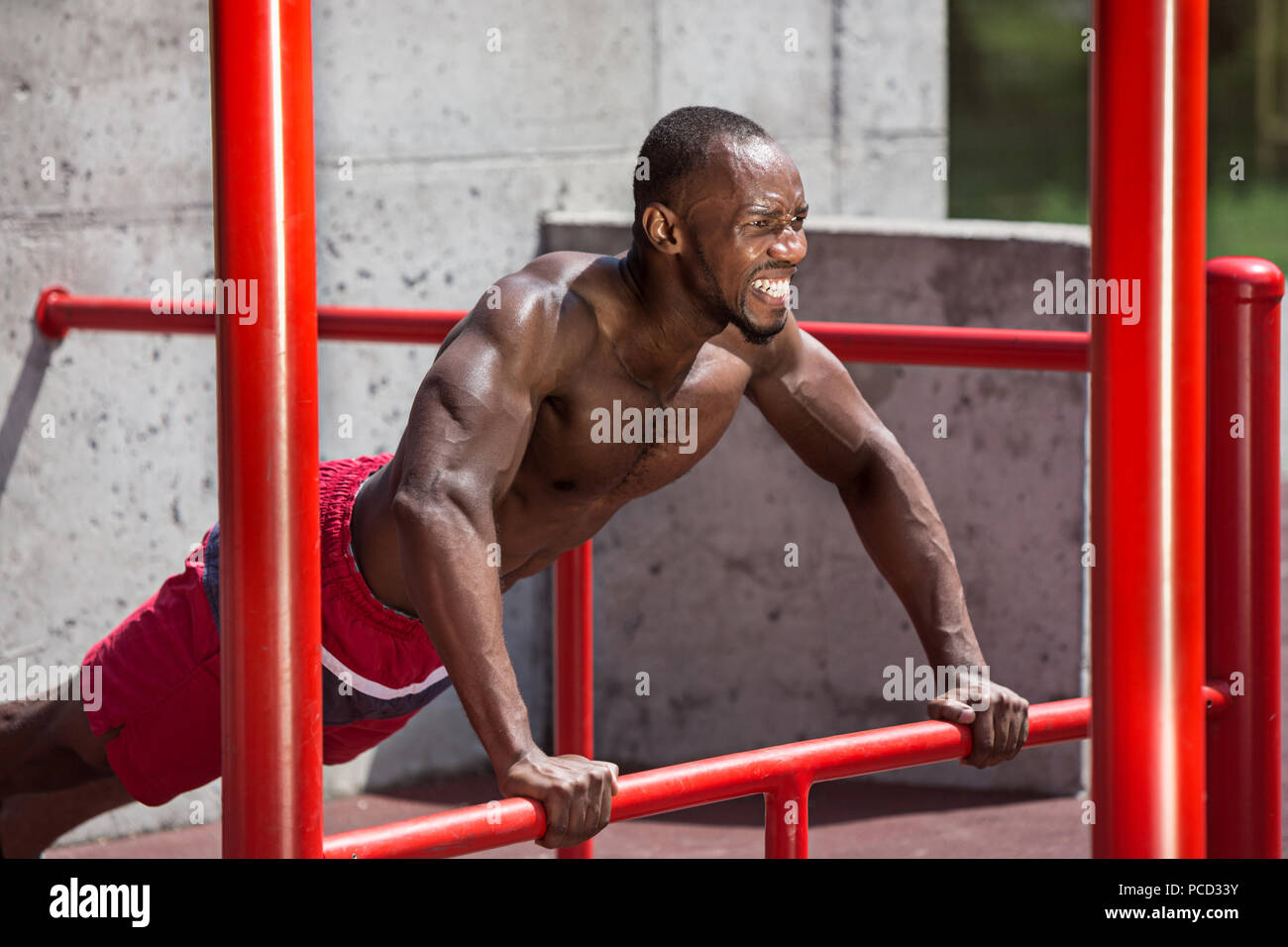 Athlete doing exercises at stadium Stock Photo - Alamy