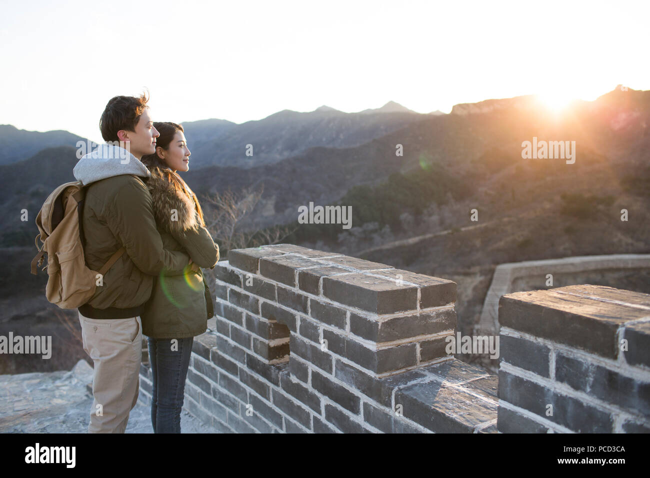 Happy young Chinese couple enjoying winter outing on the Great Wall Stock Photo - Alamy
