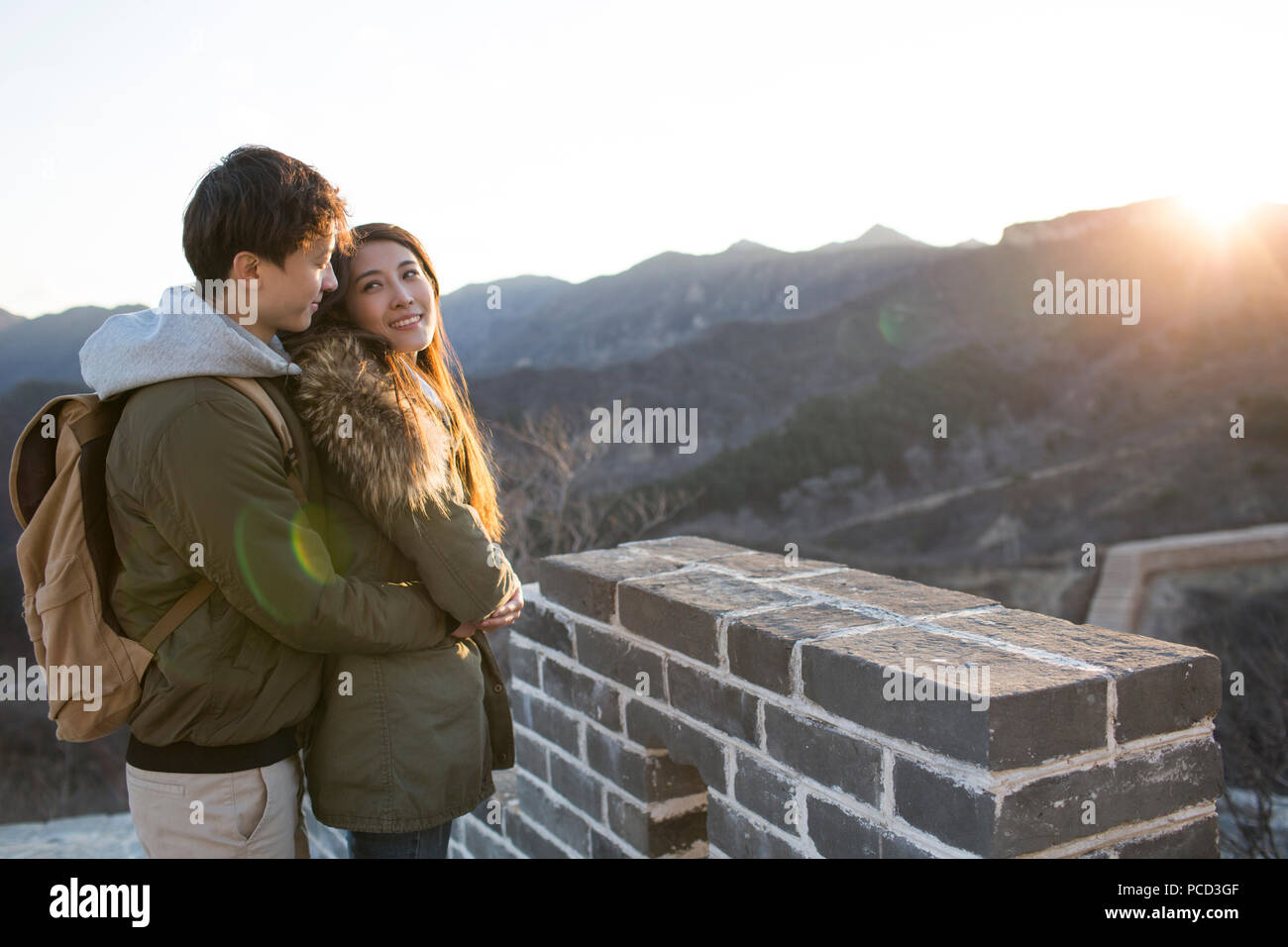 Happy young Chinese couple enjoying winter outing on the Great Wall Stock Photo - Alamy