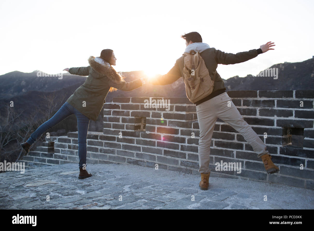 Happy young Chinese couple enjoying winter outing on the Great Wall Stock Photo - Alamy