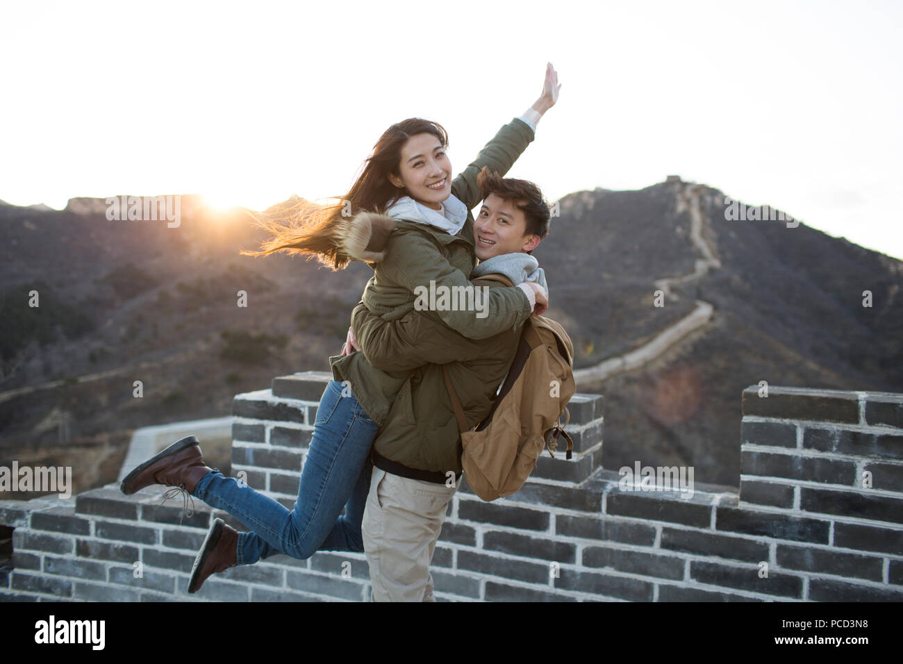 Happy young Chinese couple enjoying winter outing on the Great Wall Stock Photo - Alamy