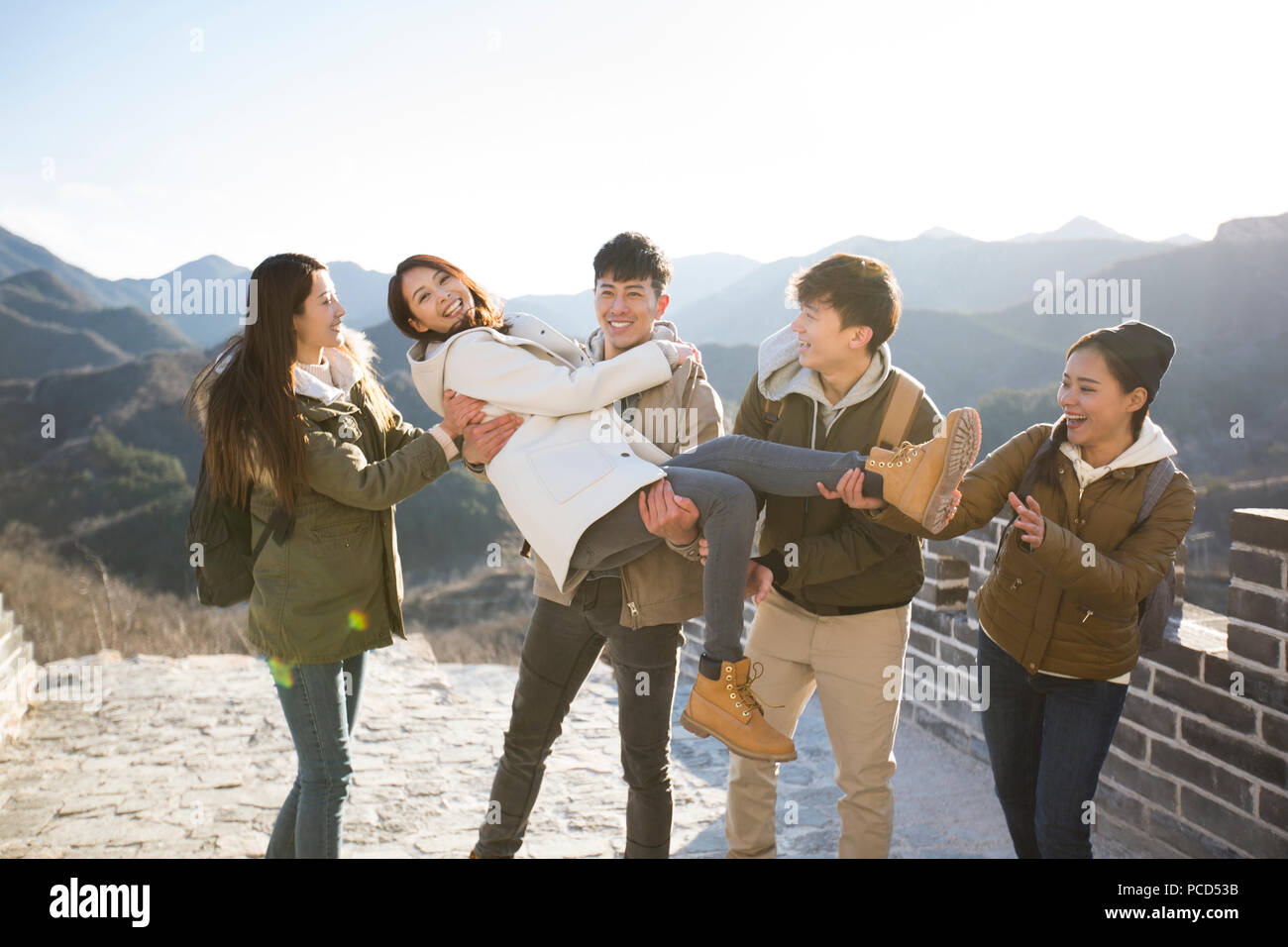 Happy young Chinese friends enjoying winter outing on the Great Wall Stock Photo - Alamy