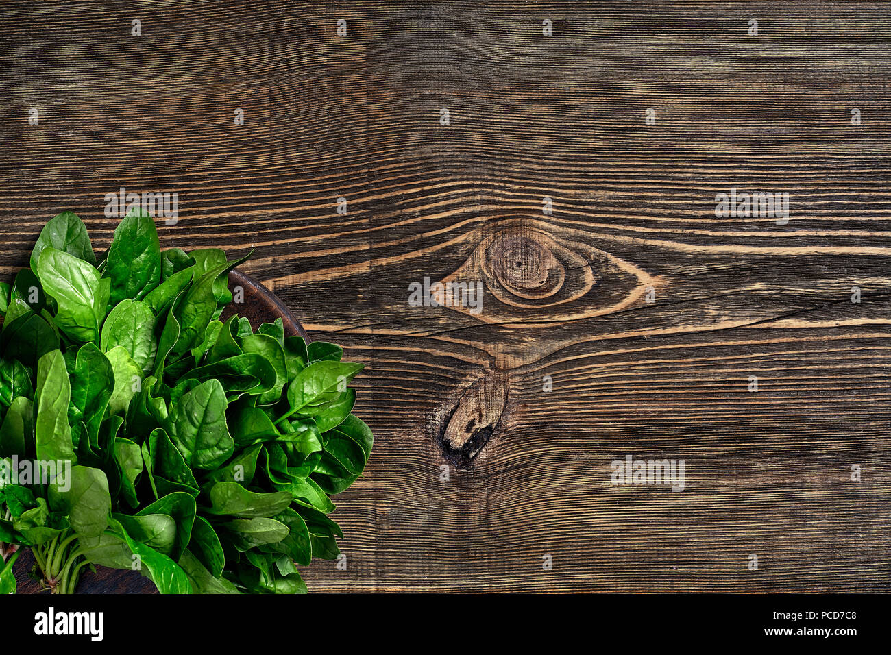 Spinach baby leaves on wooden background. Top view. Copy space. Make ...