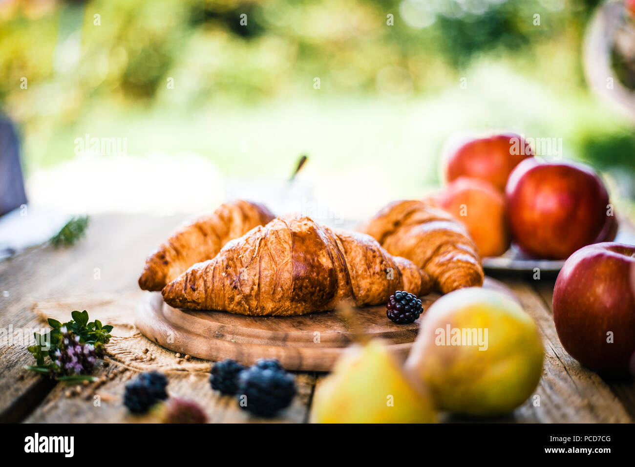 Breakfast food. Croissants on table with fresh fruit Stock Photo - Alamy