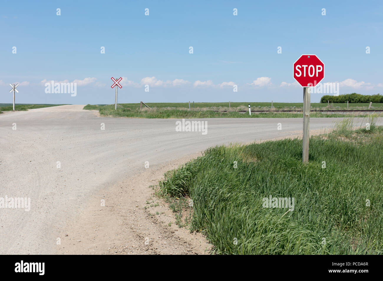 Stop sign and railroad crossing along rural road Stock Photo - Alamy