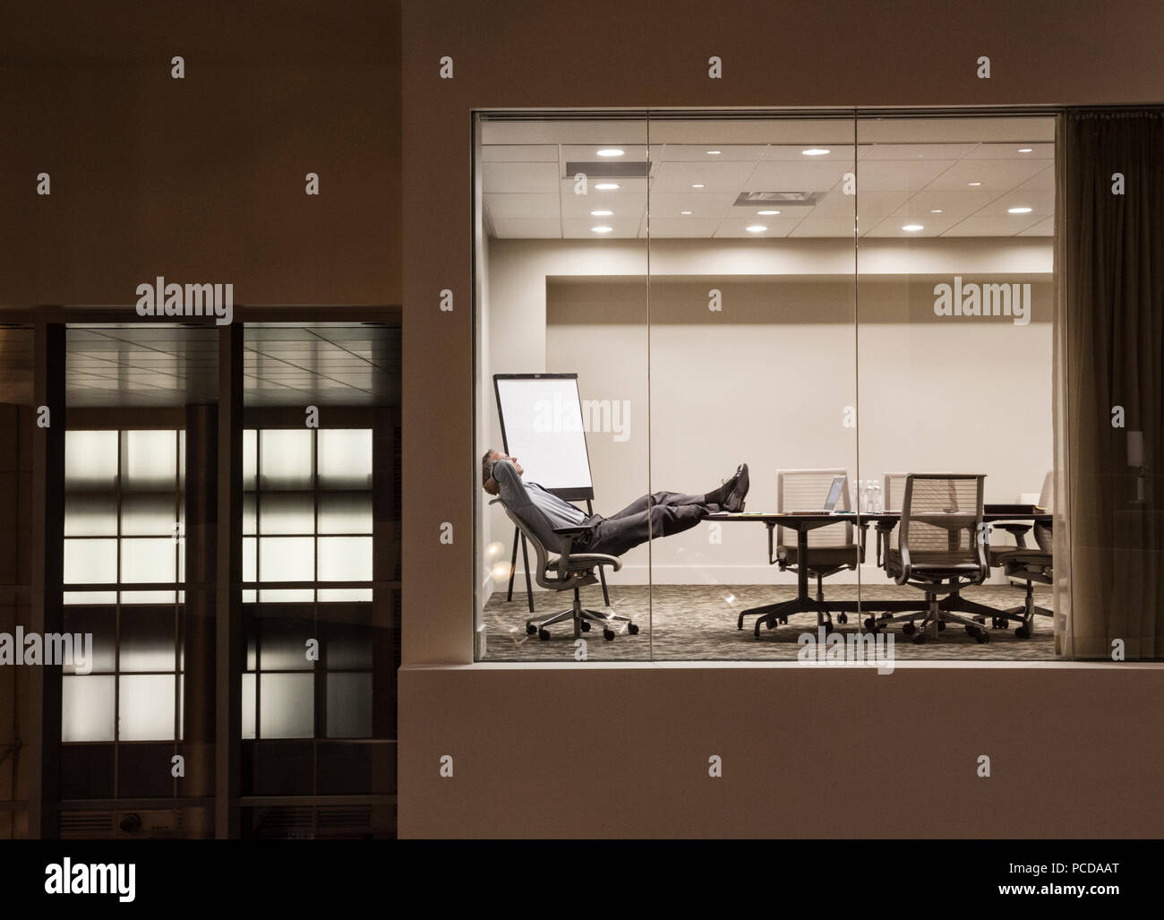 A view looking into a conference room at night with a single ...