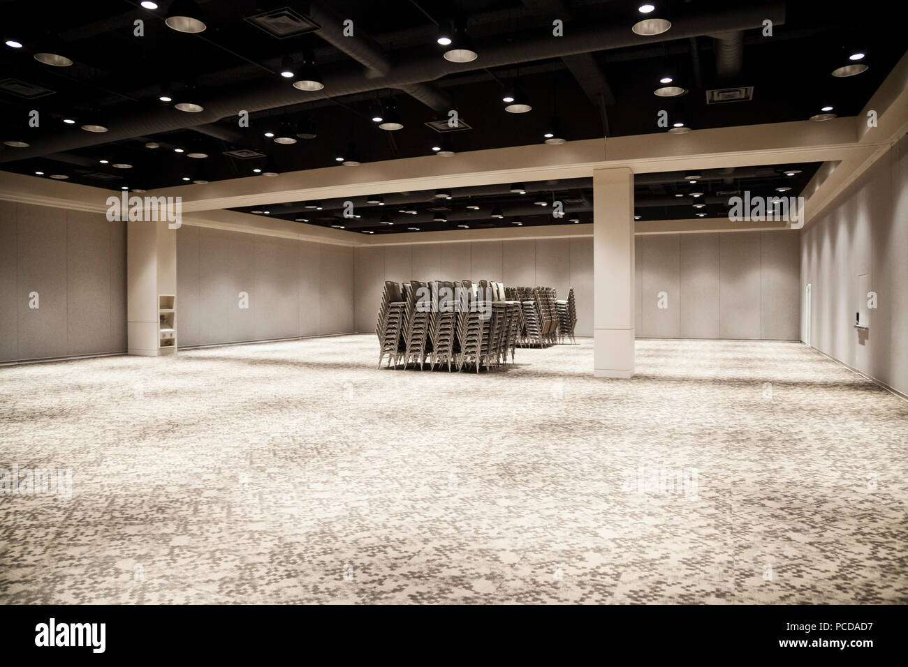 Stacked chairs in an empty convention center meeting room Stock Photo ...