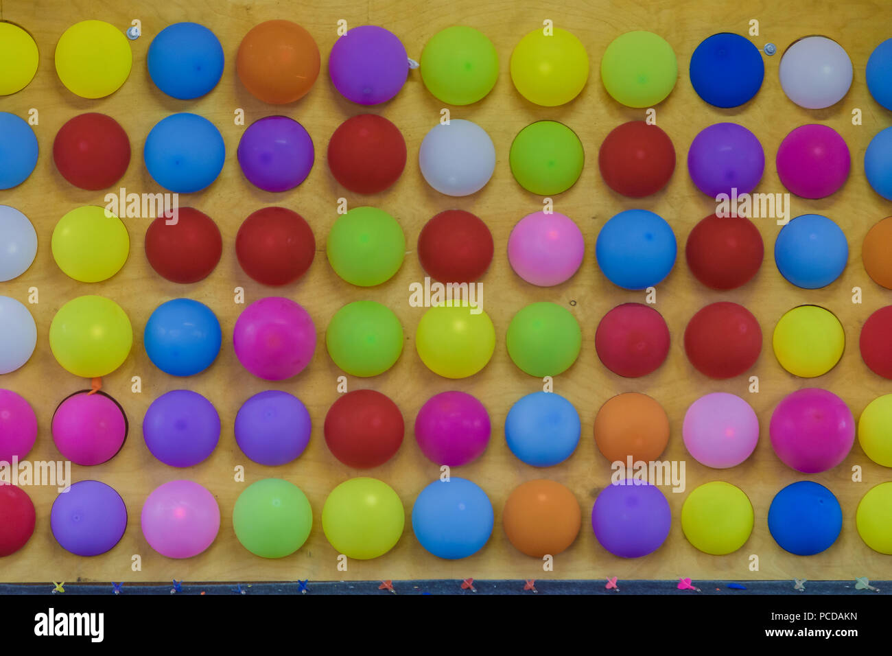 Colored balls on a wooden wall, new design Stock Photo - Alamy