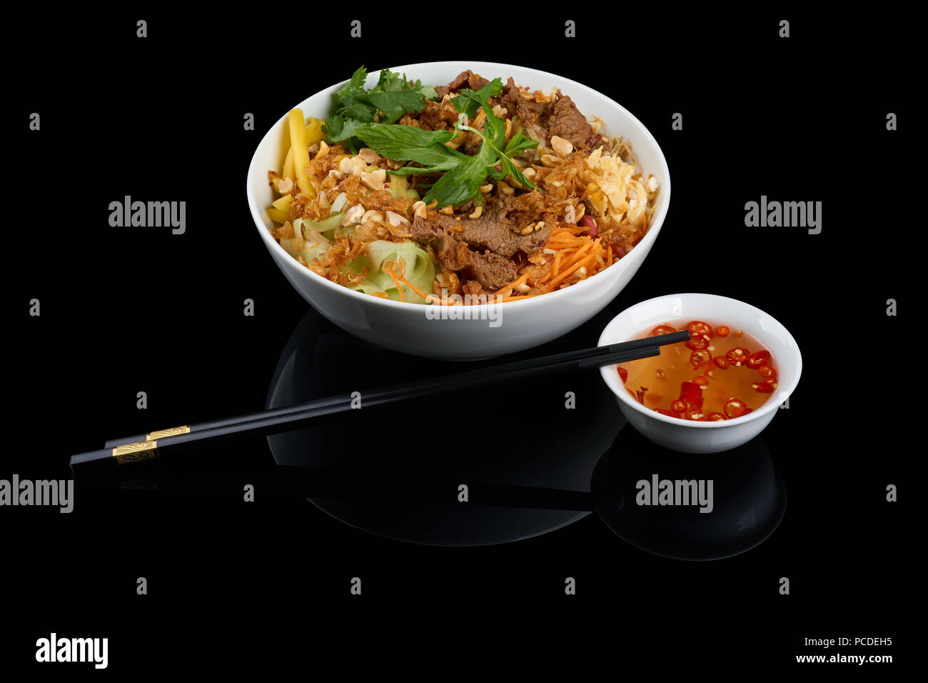 Vietnamese Fo Chon on black reflecting background. Served with ...