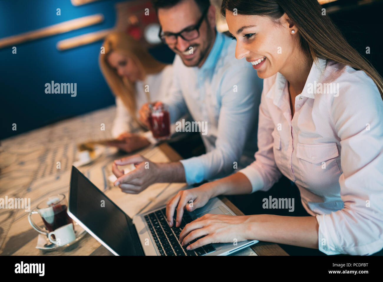 Happy colleagues from work socializing in restaurant Stock Photo - Alamy