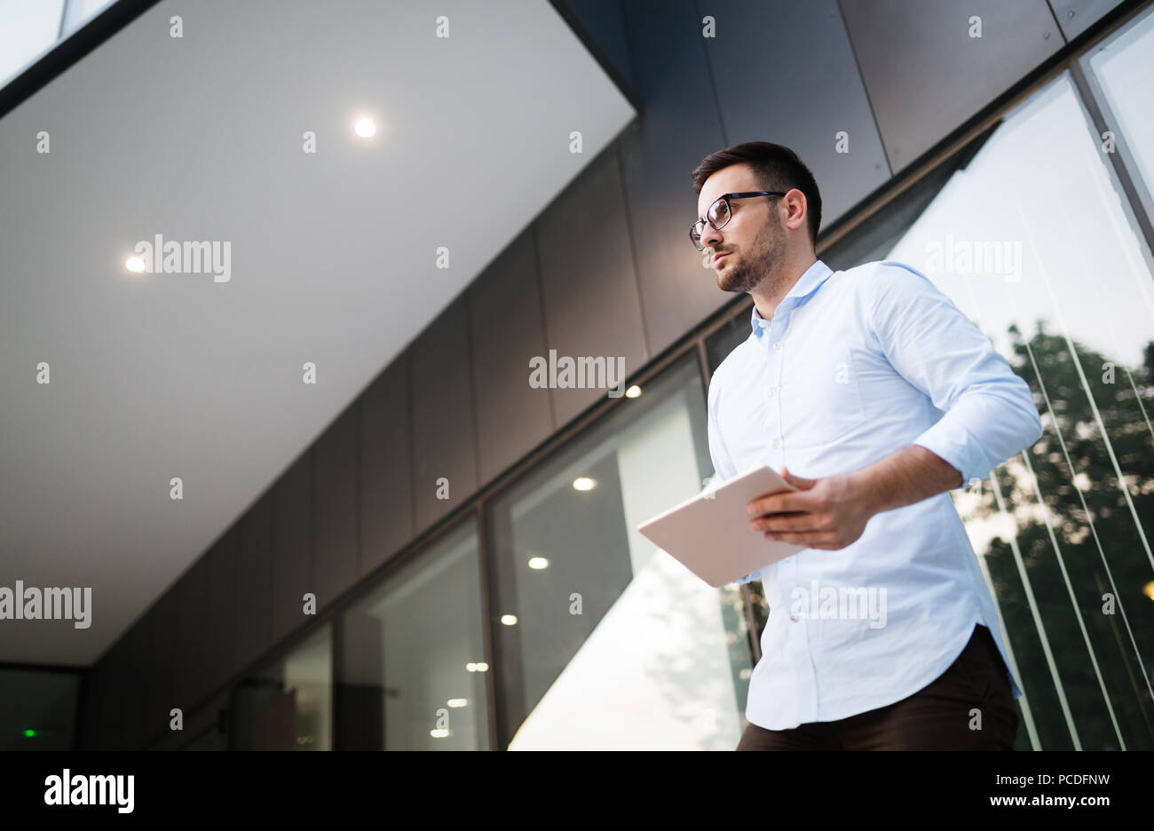 Businessman having tablet and phone at hand Stock Photo - Alamy