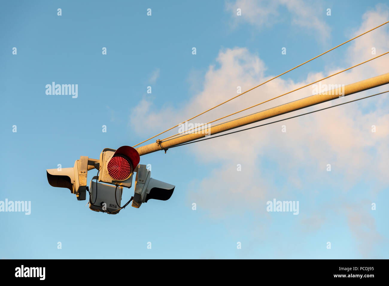 Red traffic light against light blue sky; Yomitan, Okinawa, Japan Stock ...