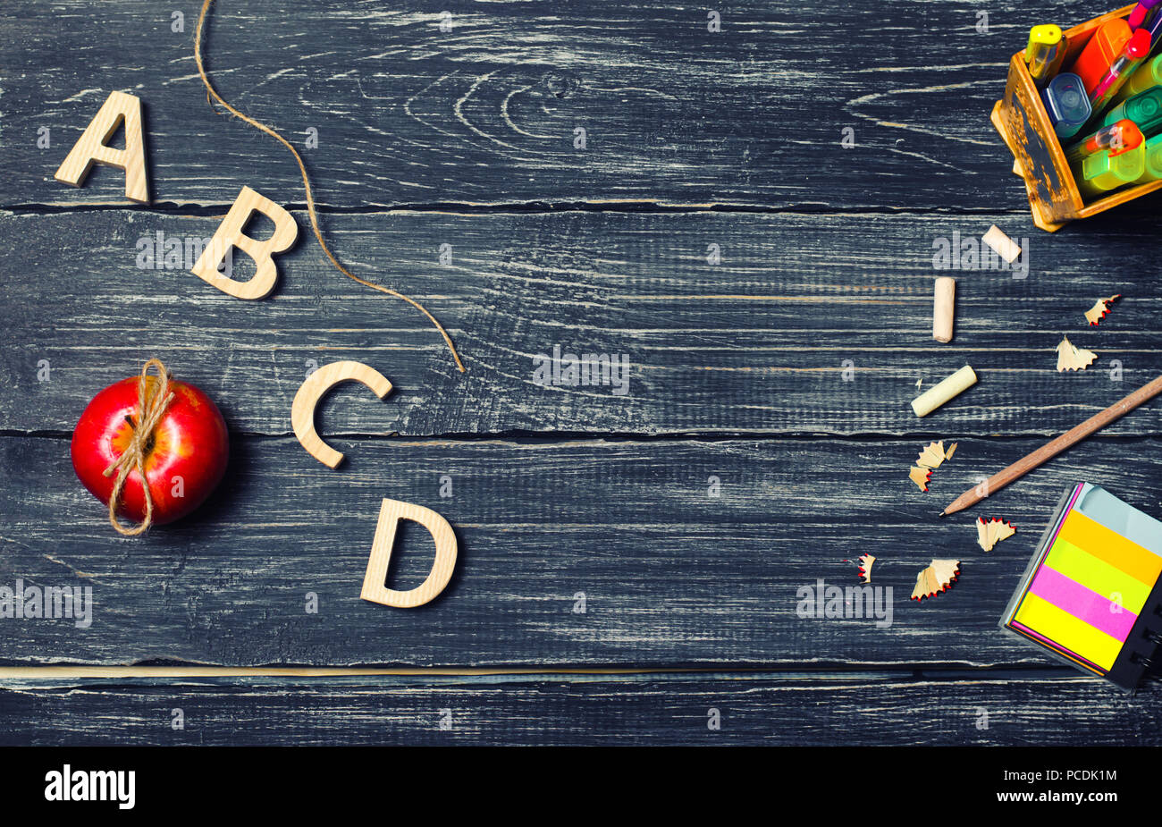 A student's desk on a school board, a dark wooden background made of ...