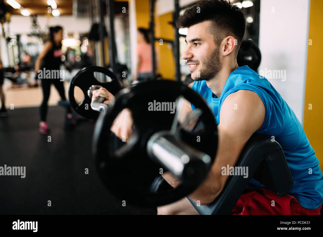 Athlete muscular bodybuilder in gym training biceps Stock Photo - Alamy