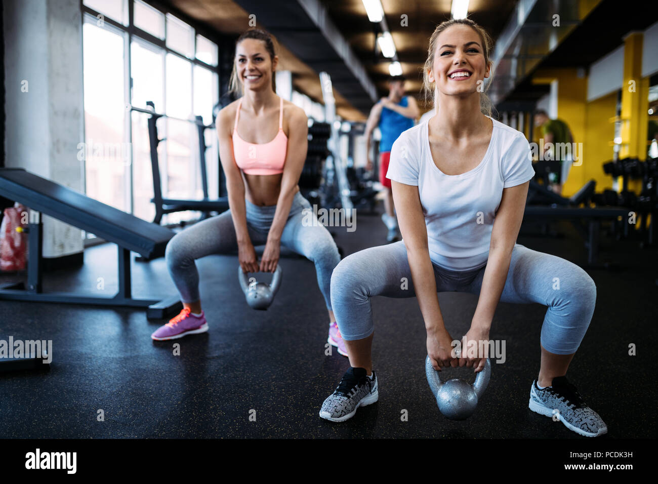 Young women doing exercises in gym together Stock Photo - Alamy