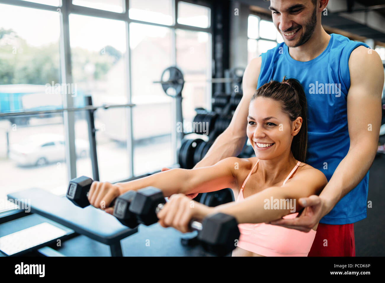 Personal trainer giving instructions in gym Stock Photo - Alamy