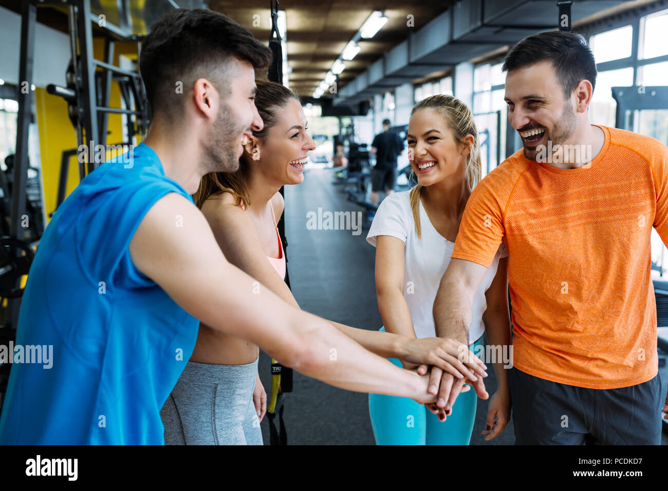 Happy fitness class giving high-five after completing exercise session ...