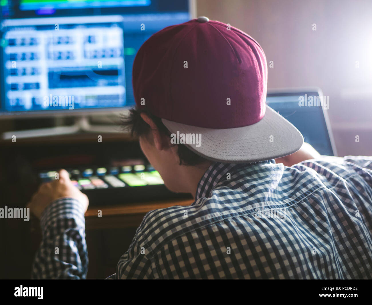 young smiling happy man in the sound recording studio working on the ...