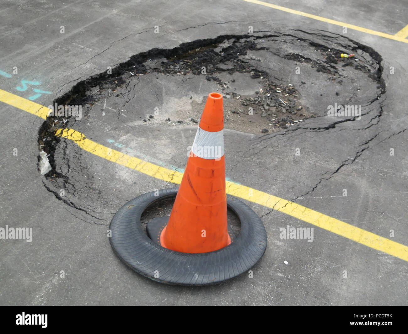 Constructions at unexpected sink hole in public parking lot with ...