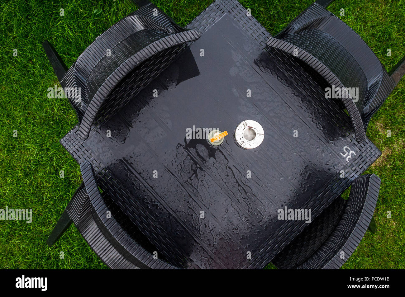 Empty outside restaurant table after a rain storm Stock Photo - Alamy