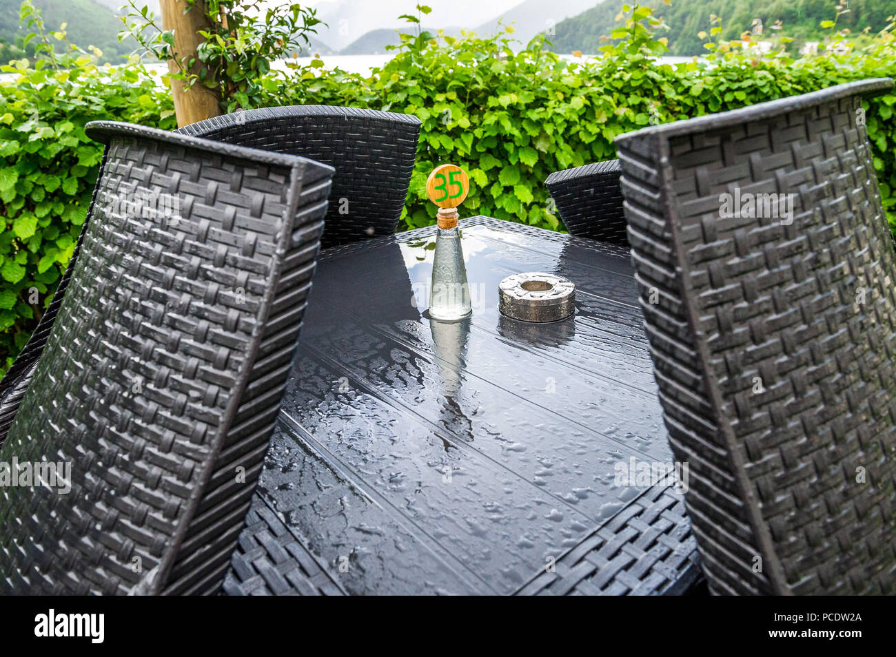 Empty outside restaurant table after a rain storm Stock Photo - Alamy
