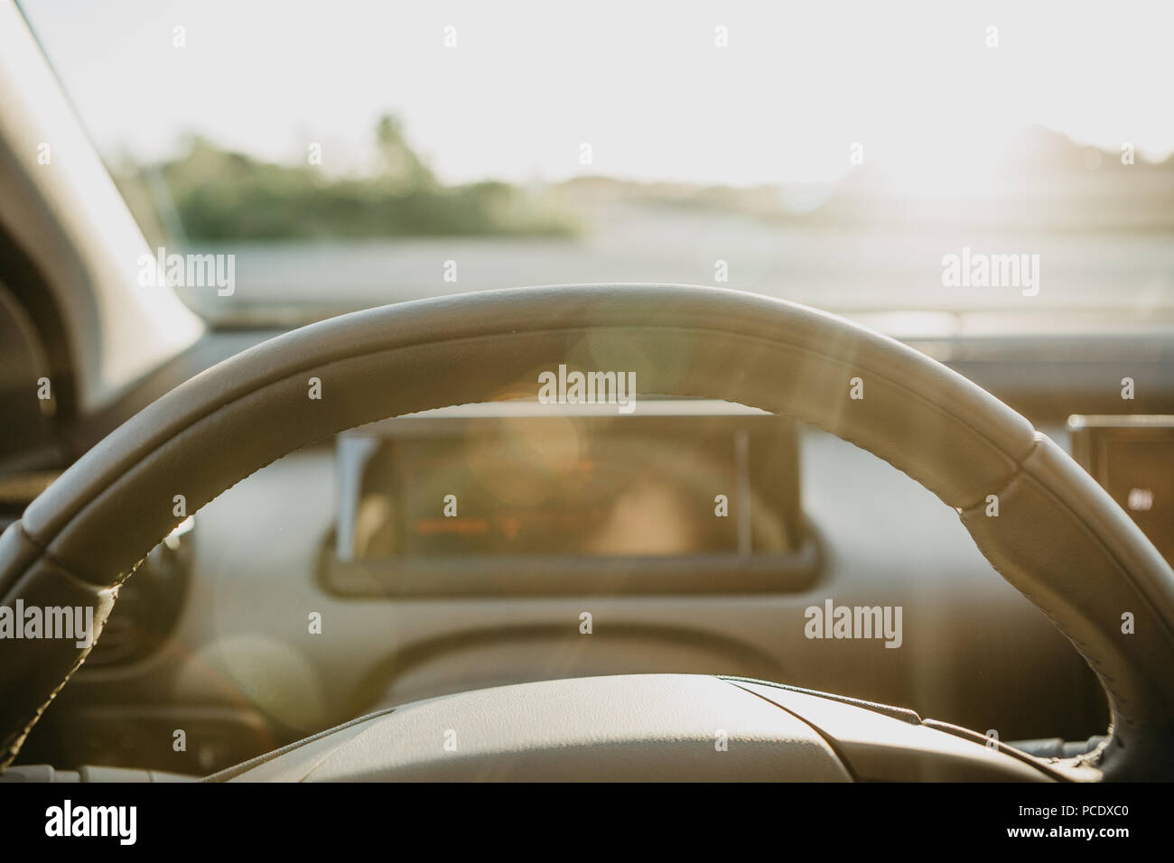 Conceptual picture of a road trip. Close-up steering wheel and view ...