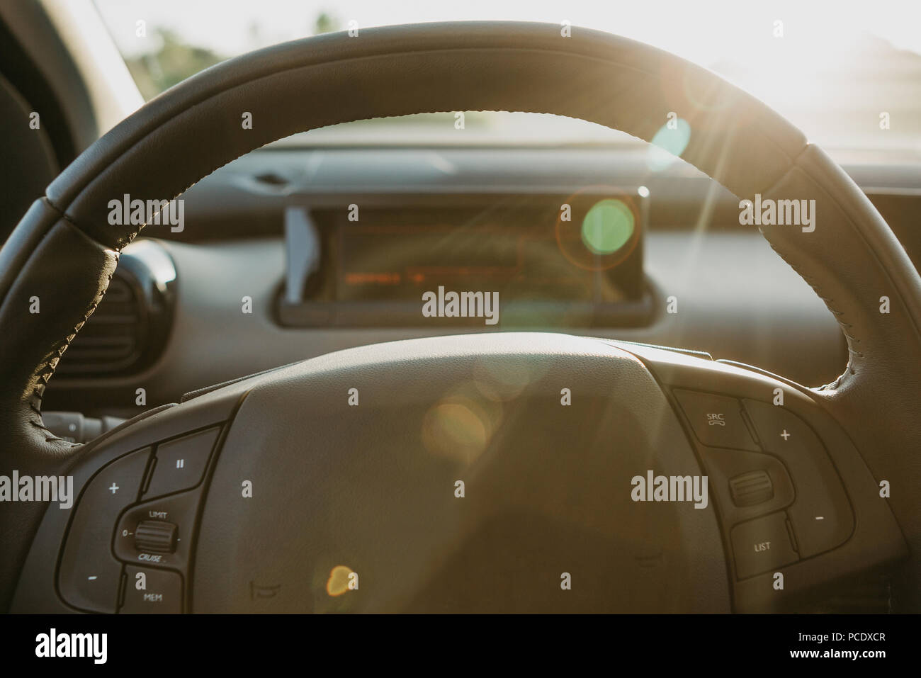 Conceptual picture of a road trip. Close-up steering wheel and view ...