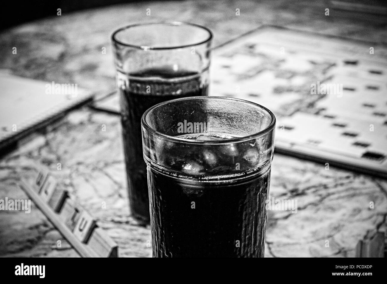 Classic scene from a game night scrabble, with drinks and the game in ...