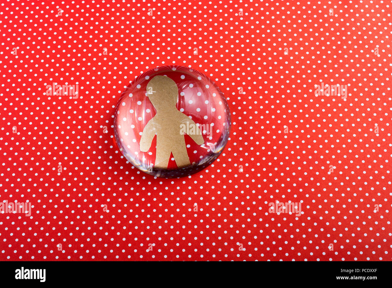 Paper man shape in under half a globe in the view Stock Photo - Alamy