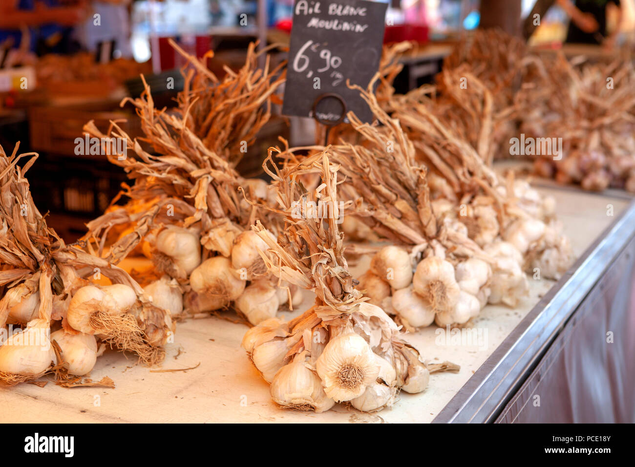 Bunches of fresh white garlic bulbs and cloves for sale on French ...