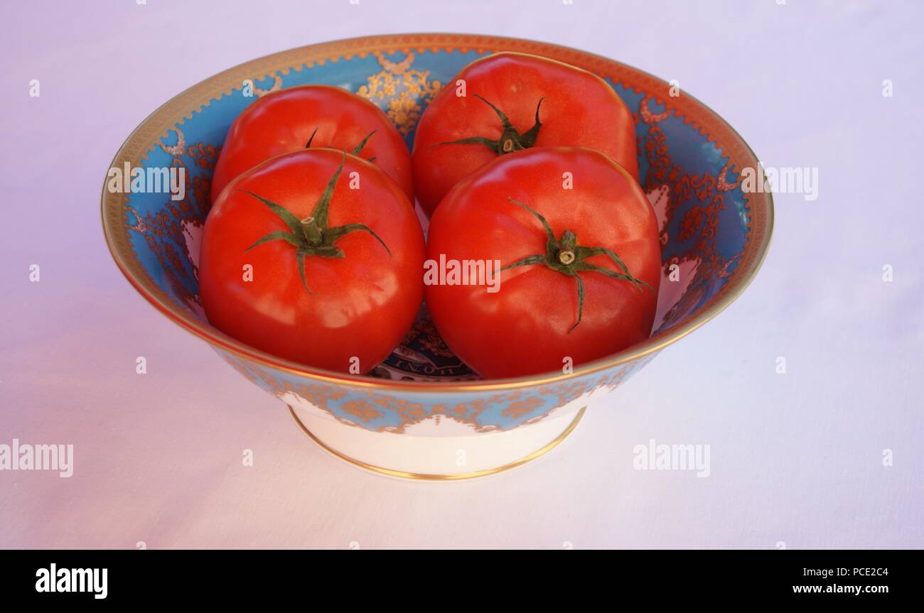 Crisp red beef tomatoes in a bon china porcelain bowl Stock Photo - Alamy