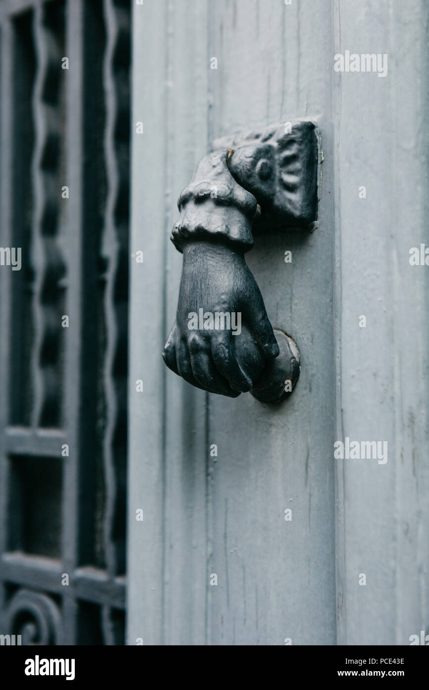 Close-up. Vintage handle for knocking on the door in the form of a hand ...