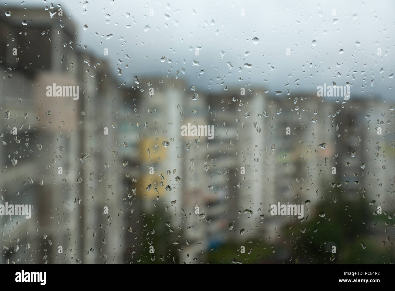 Rain drops on the glass overlooking the residential area Stock Photo ...