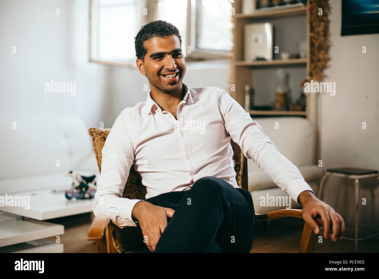 Confident and cheerful Syrian man is laughing during a conversation ...
