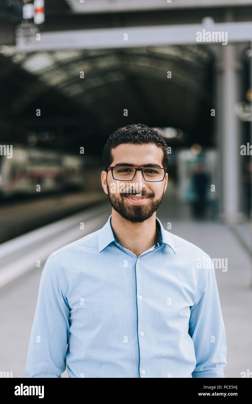 Portrait of handsome and cheerful syrian man at the train station Stock ...