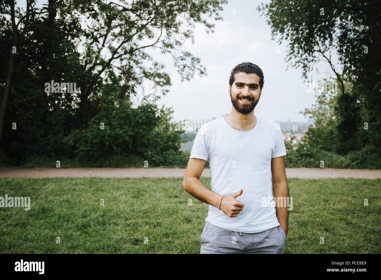 Outdoor portrait of cheerful Syrian man giving the thumbs up Stock ...