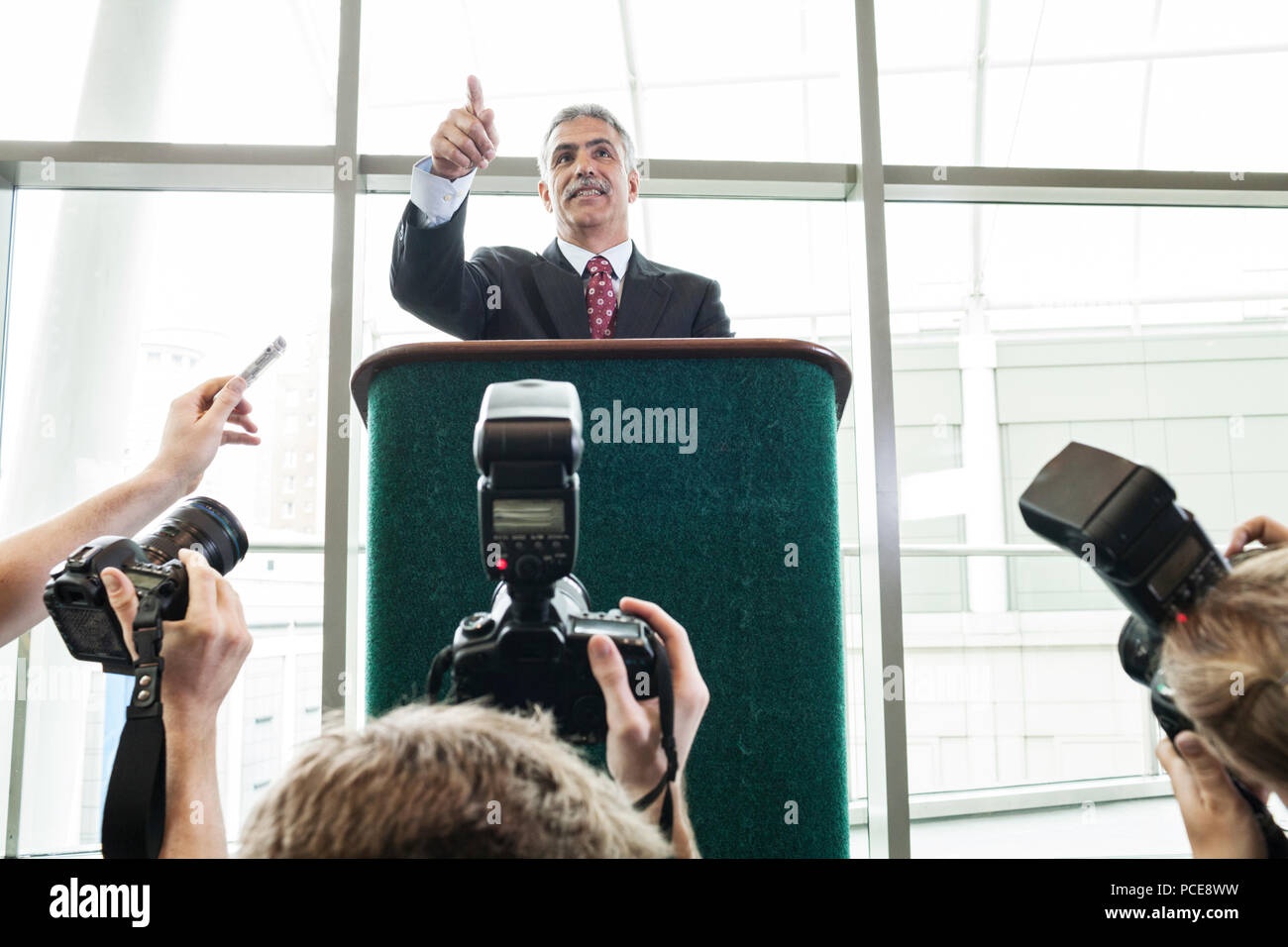 Photographers taking photographs at a political gathering and speech ...