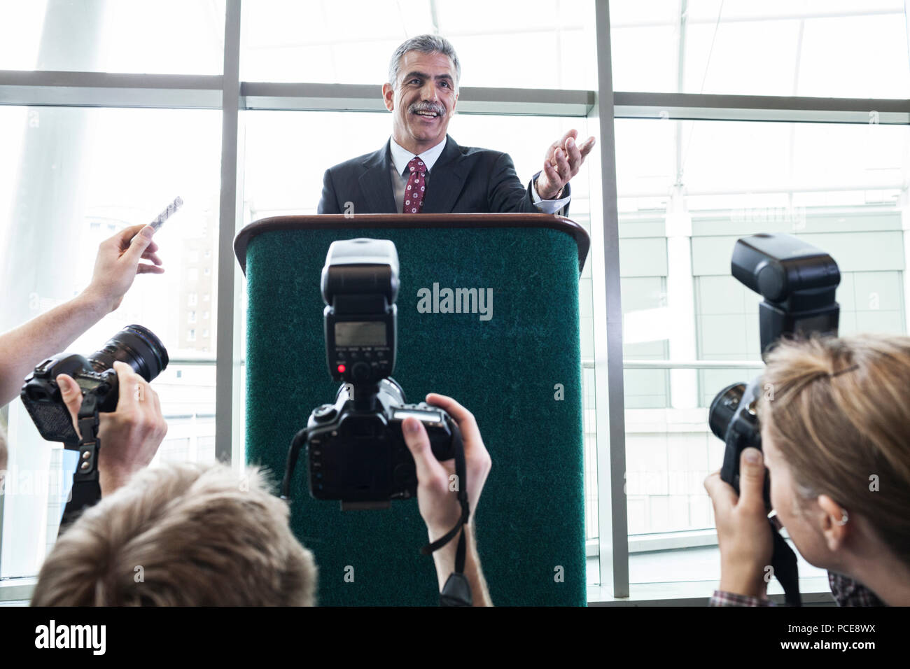 Photographers taking photographs at a political gathering and speech ...