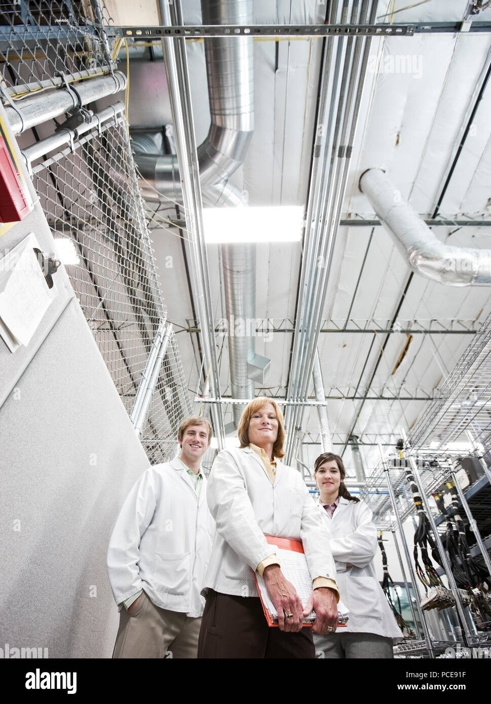 A portrait of a team of technicians in a technical research and ...