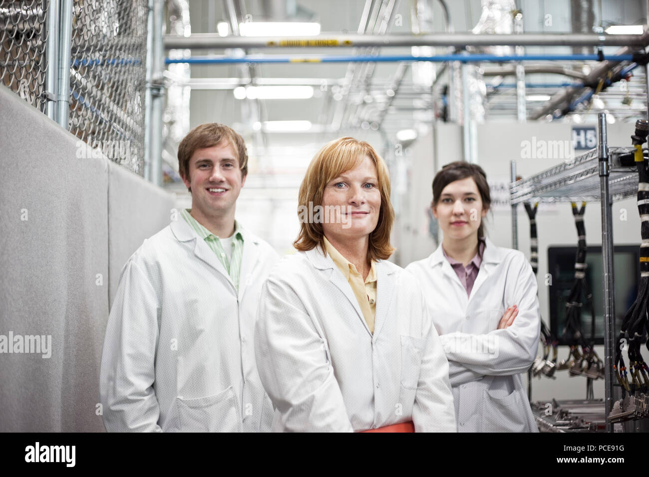 A portrait of a team of technicians in a technical research and ...