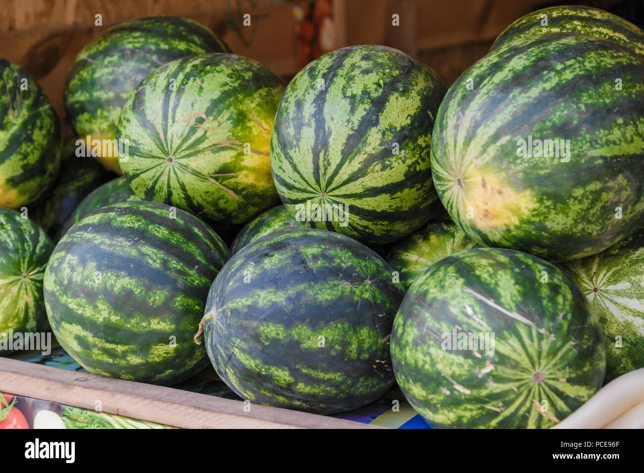 Pile of fresh ripe watermelons lying in wooden boxes in fruit and ...