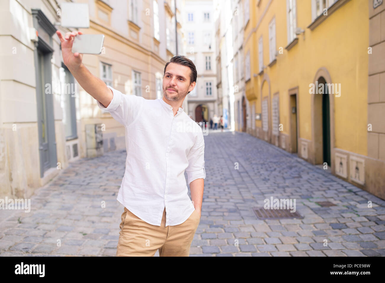 Man tourist with a city map and backpack in Europe street. Caucasian ...