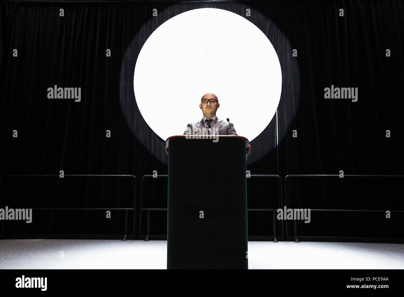 Businessman standing podium hi-res stock photography and images - Alamy