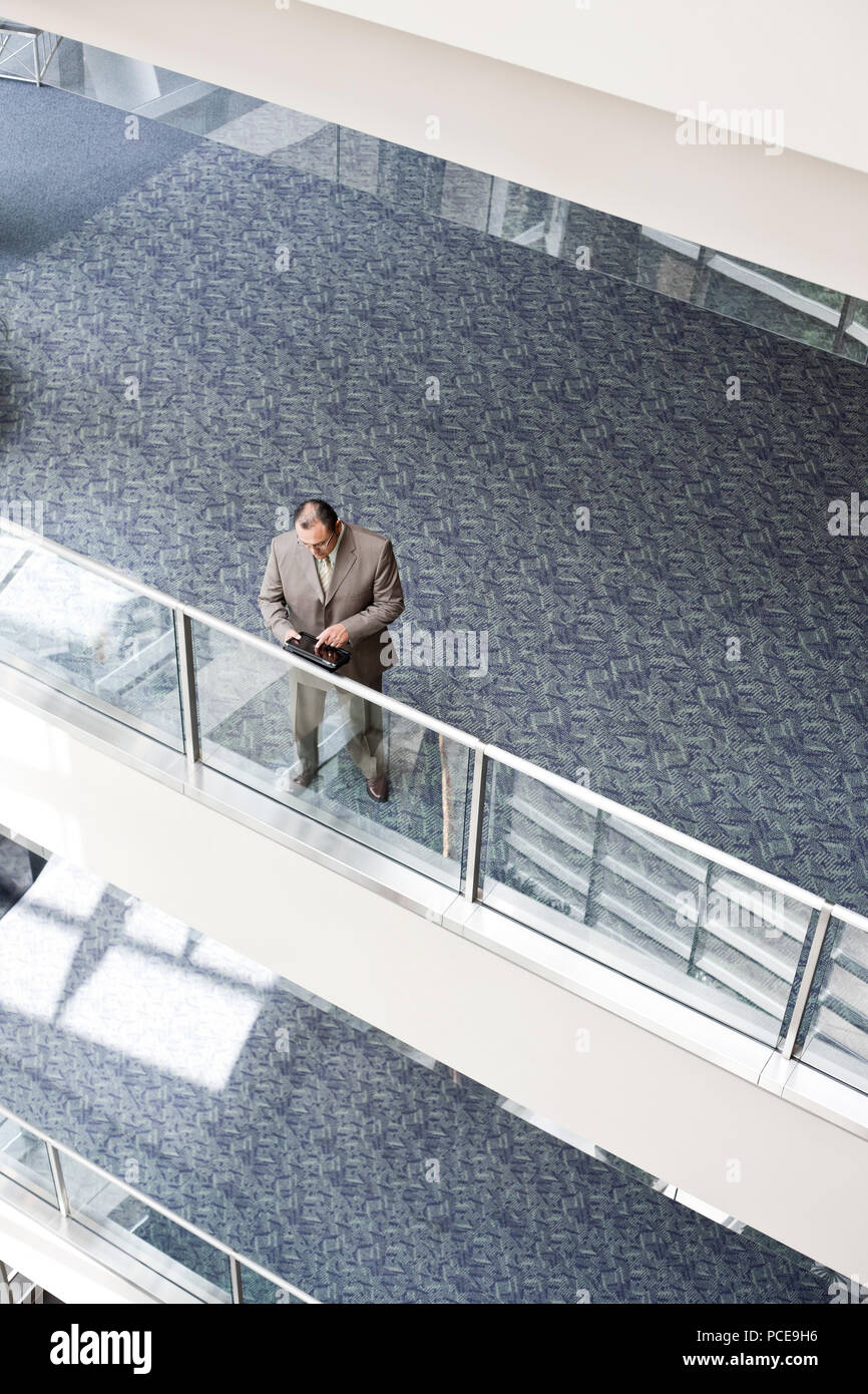 View looking down on an hispanic businessman checking his notebook ...
