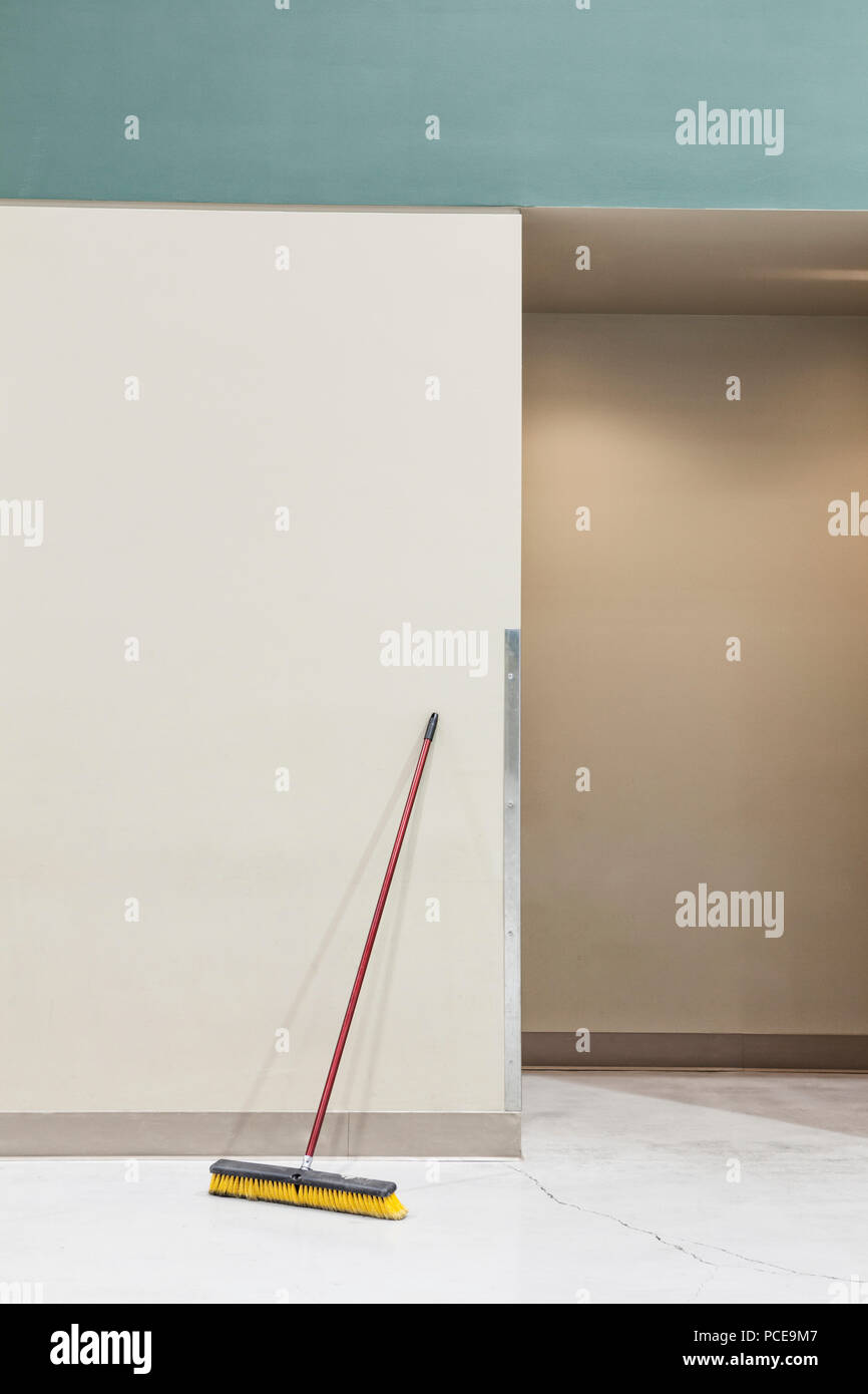 A still life view of a broom leaning up against a wall Stock Photo - Alamy