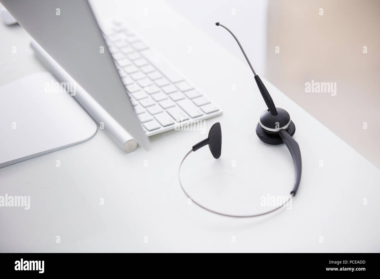 Headset on desk in office Stock Photo - Alamy