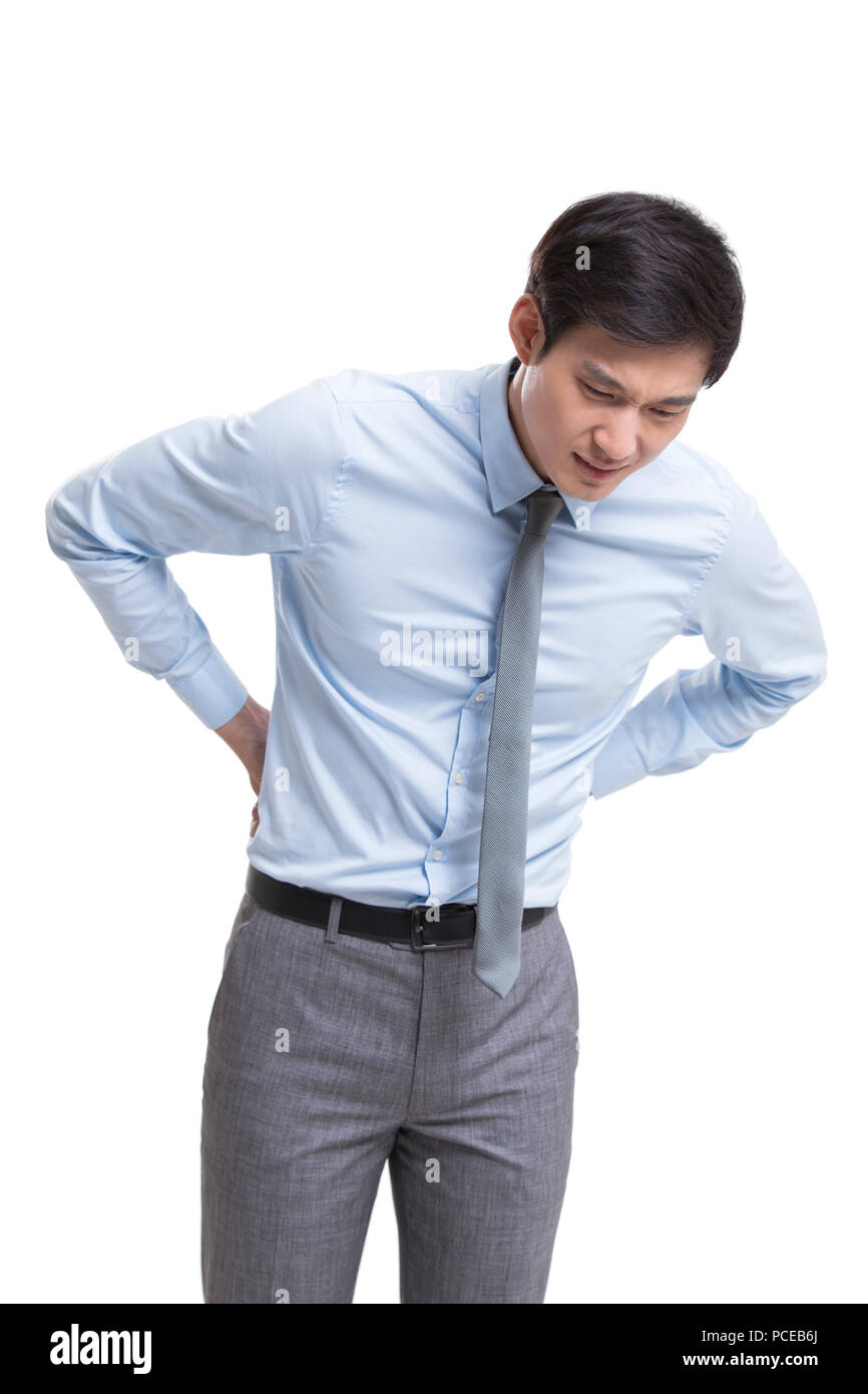Young Chinese businessman suffering from backache Stock Photo - Alamy