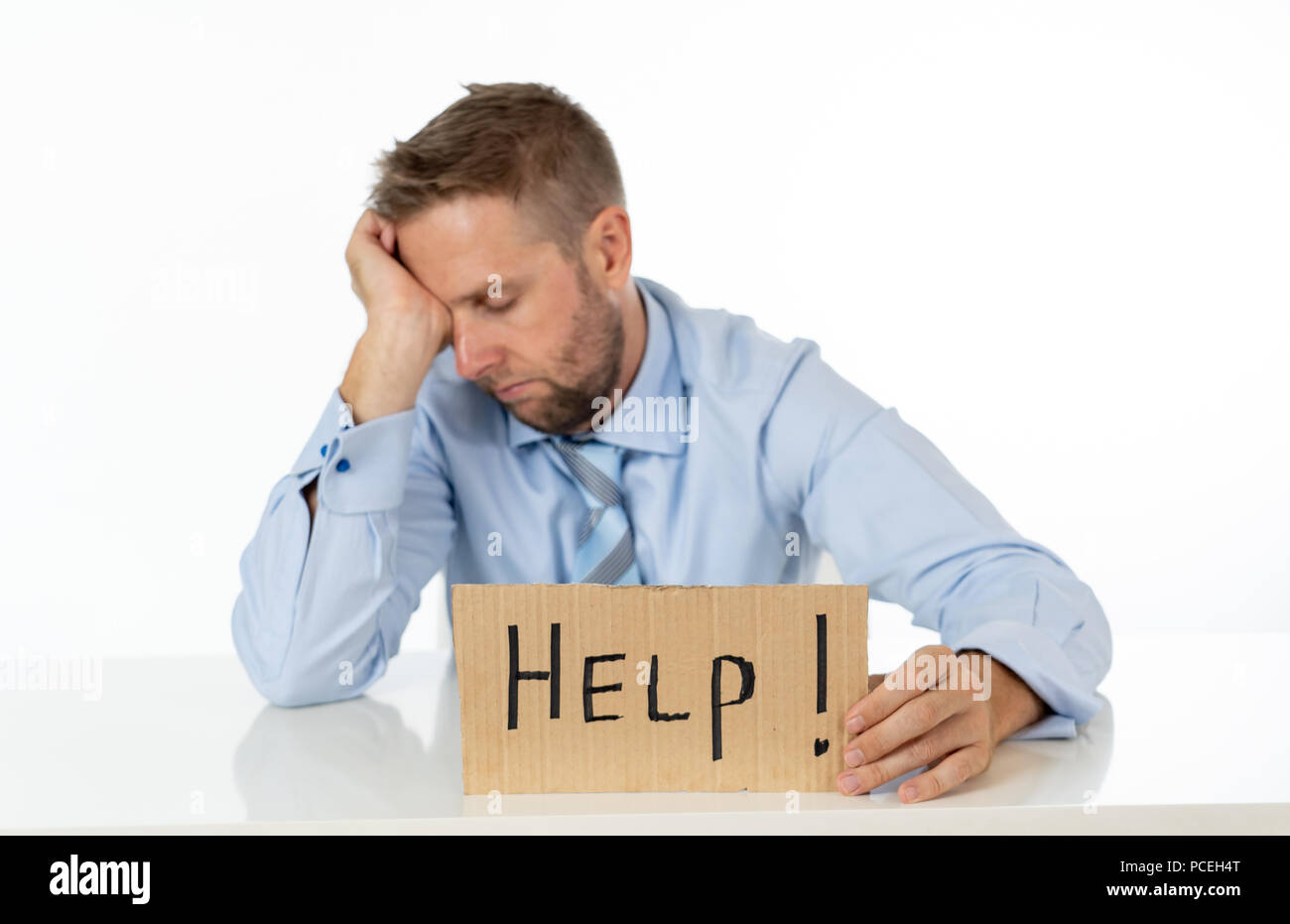 Businessman holding help sign message Stock Photo - Alamy